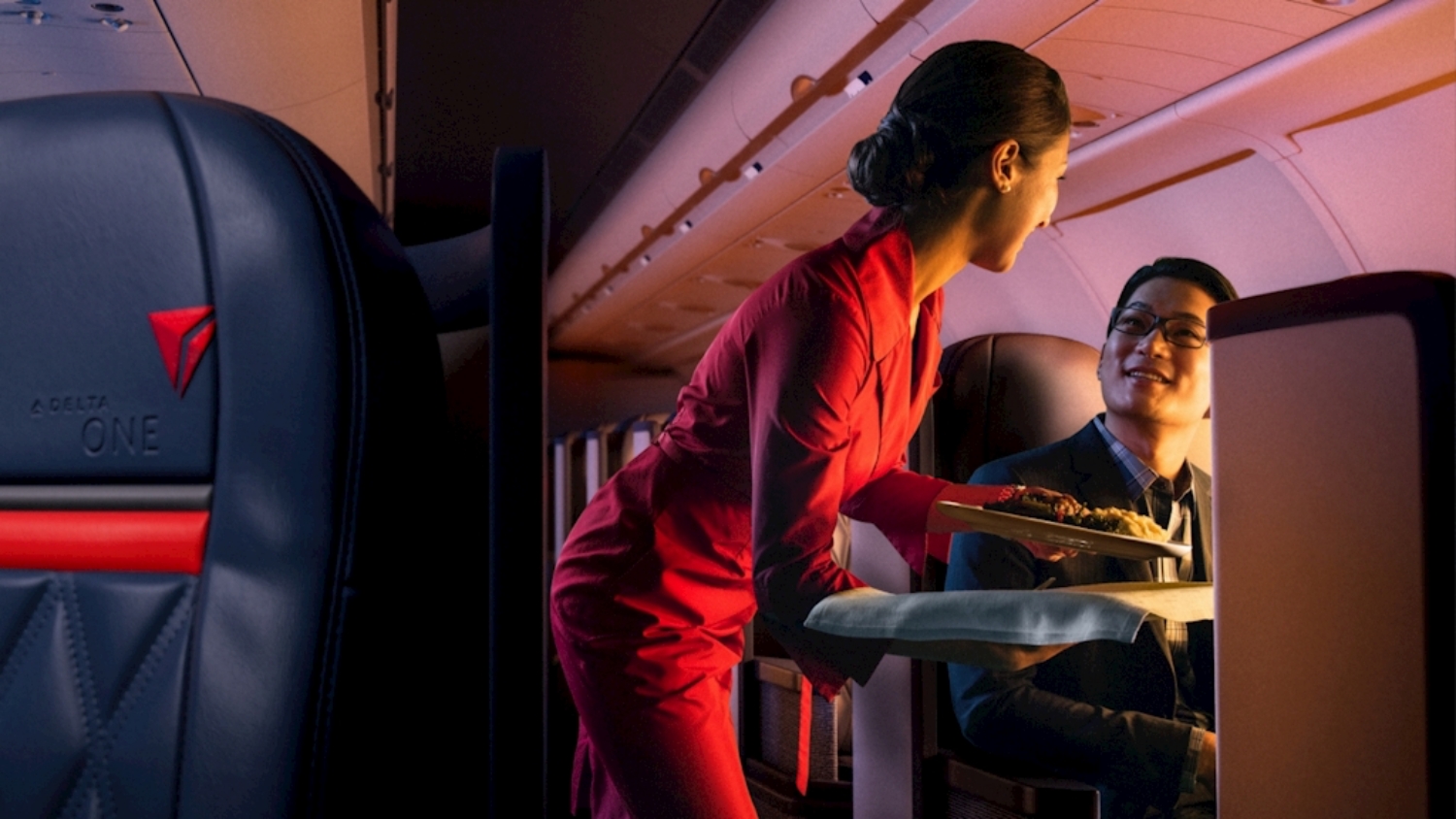 Flight Attendant serving Delta One customer - Wayfarer